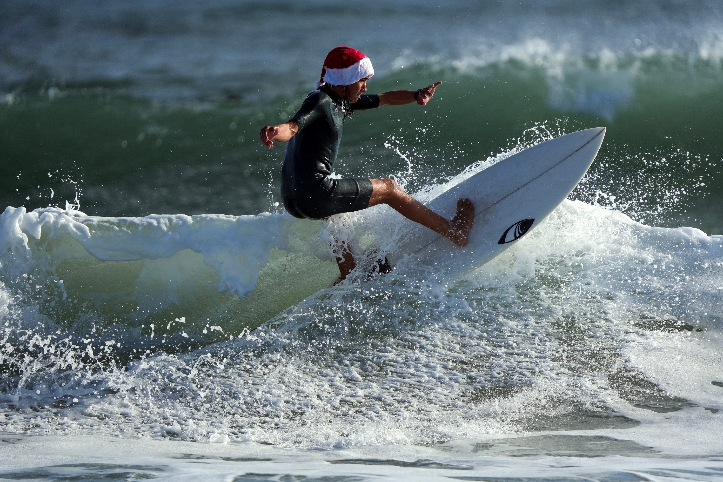 Before the big sleigh ride, Santas hit the Treasure Coast surf Dec. 24