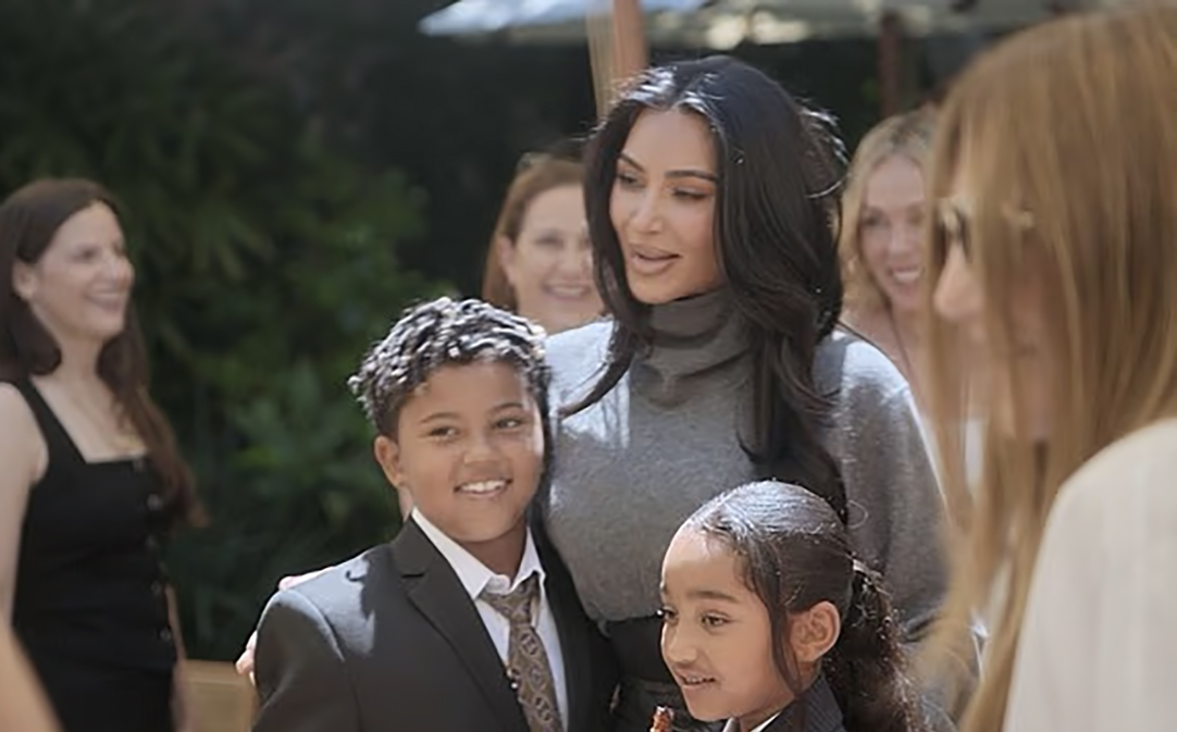 Kim Kardashian mortified as sons fight on stage during her law school ...