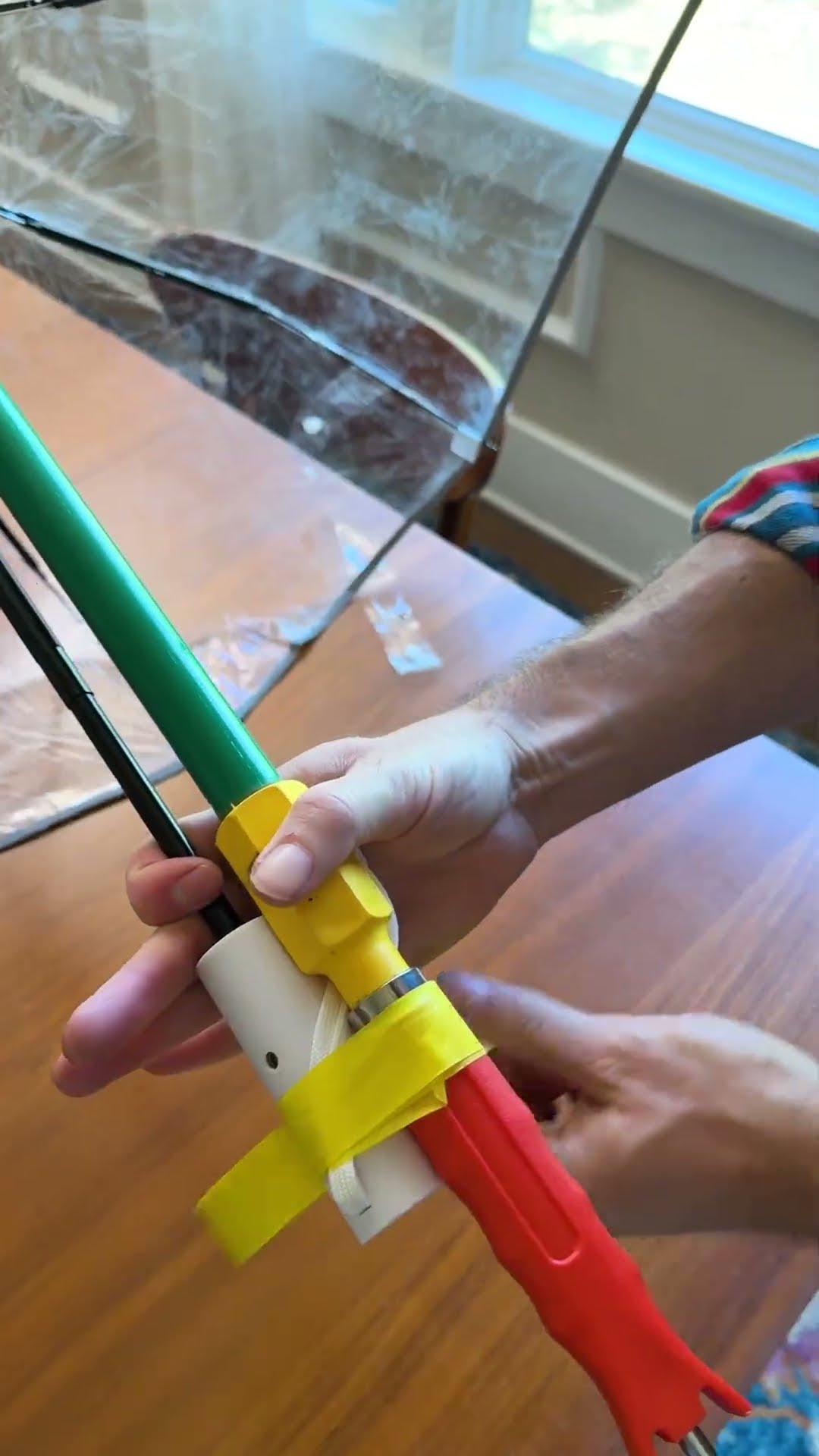 ☂️ Jeff uses an inverted umbrella to catch drips when painting the ceiling