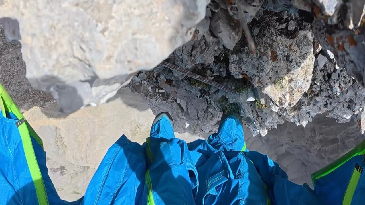 Wingsuit BASE jump along a rock spine