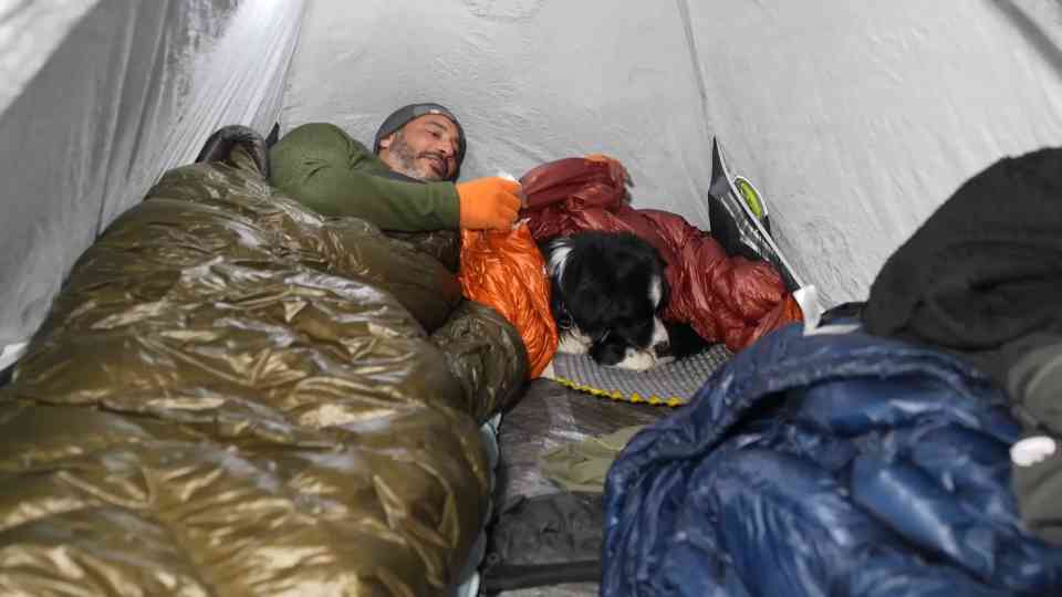 A sanctuary in the snow: A man, his dog, and a cozy winter night at ...