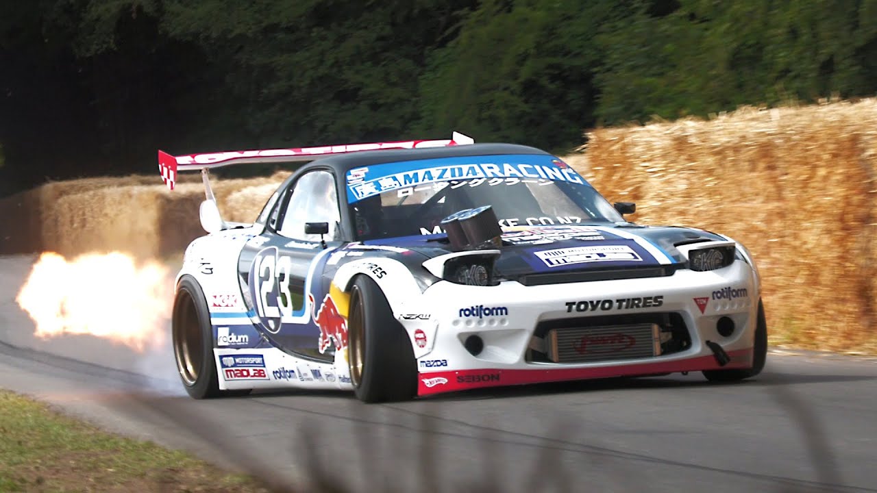 Mazda RX-7 drifts with flames on the track