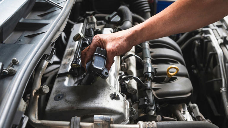 Why did cars switch from distributors to coil packs?