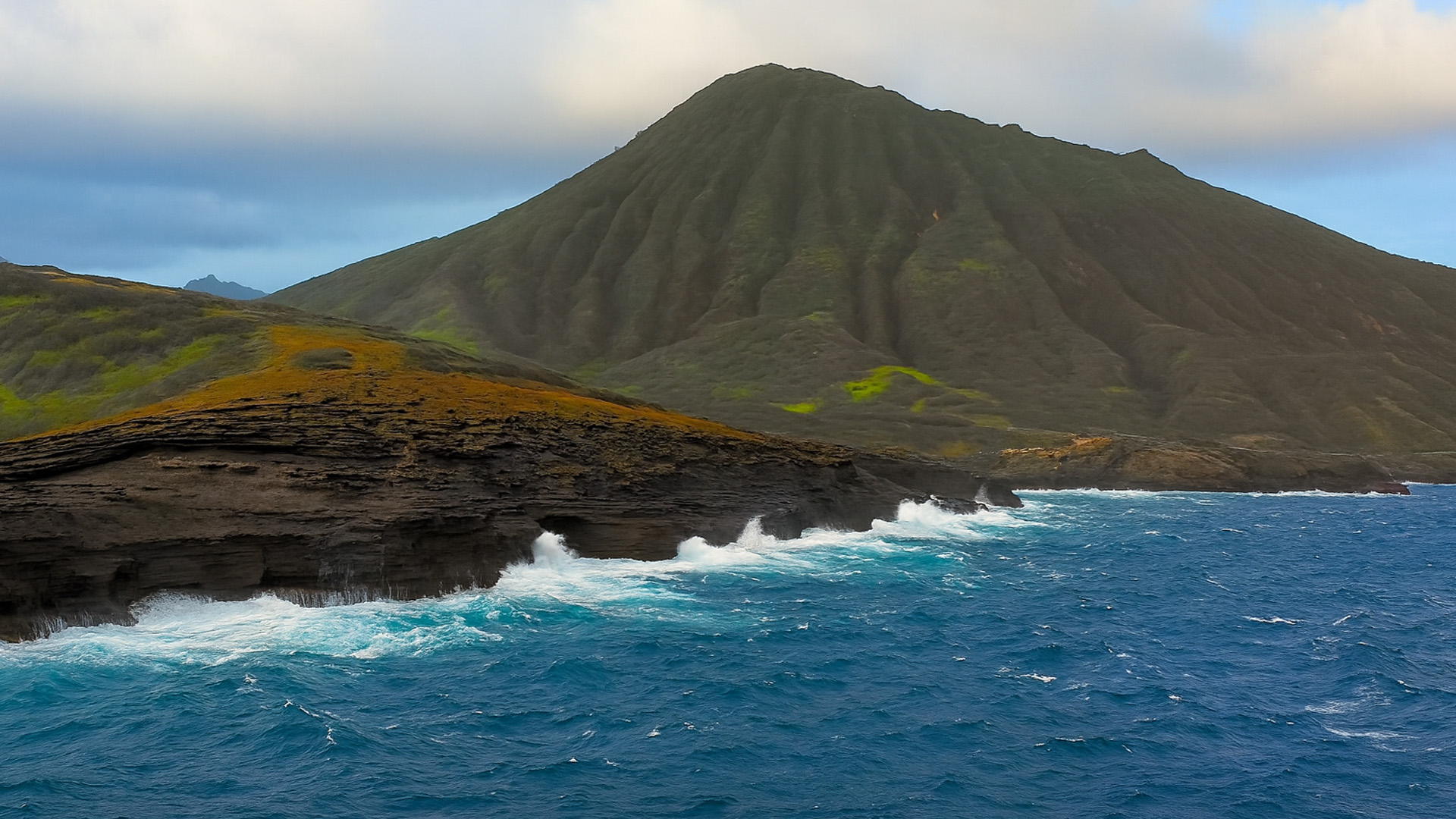 Waves crash on a sleeping volcano