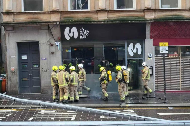 Fire crews rush to Glasgow street as smoke billows from city centre drain