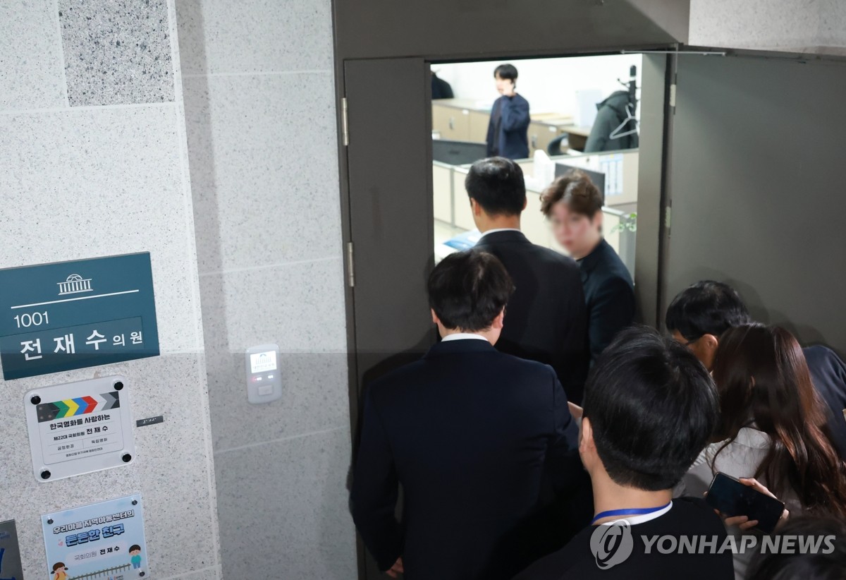 Police raid ex-minister's office over bribery case