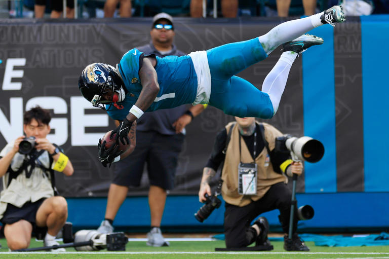 Travis Etienne gives star quarterback Trevor Lawrence some advice