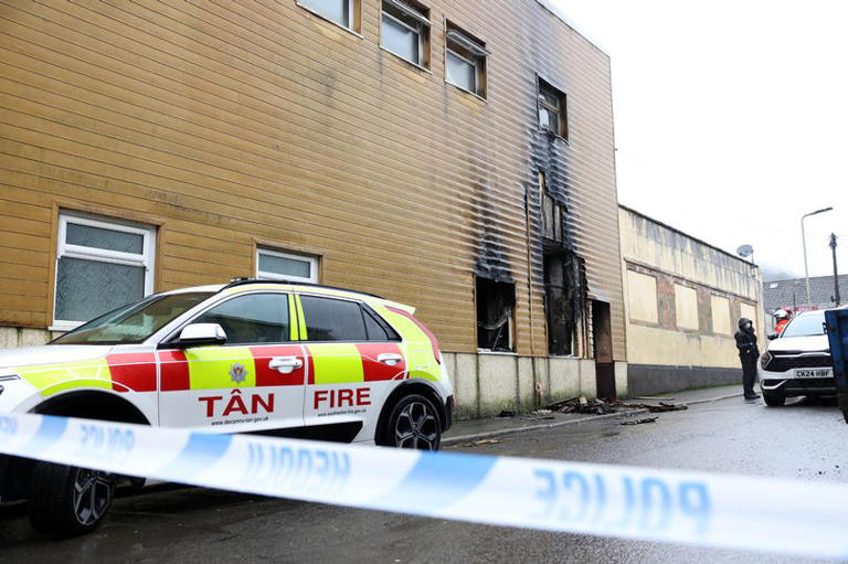 Heavy emergency services presence as fire wrecks building