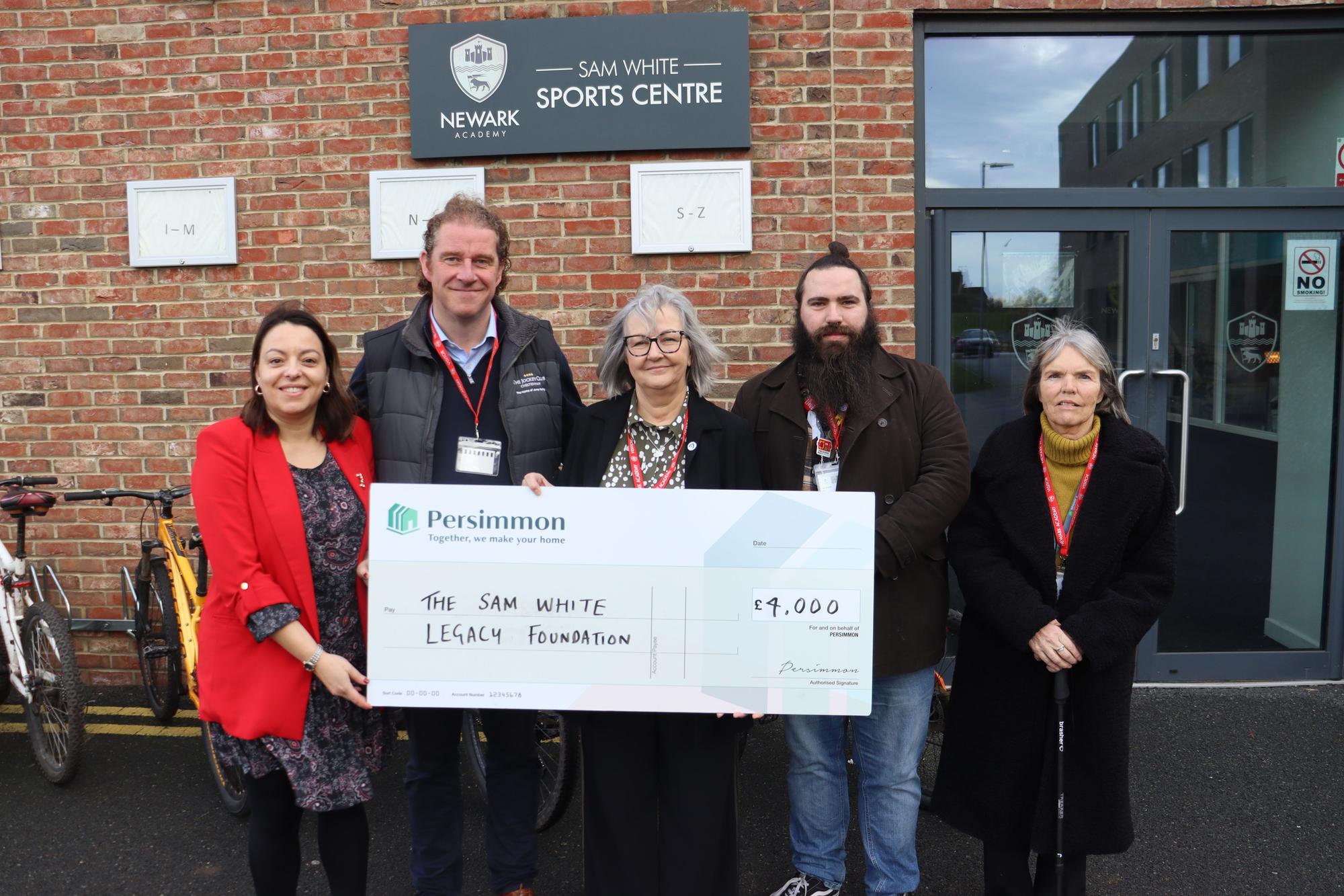 Sam White Legacy celebrating after receiving donation from Persimmon