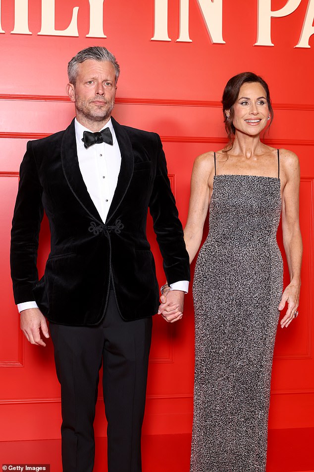 Glam Minnie Driver is supported by fiancé Addison O'Dea at the Emily in Paris series five premiere