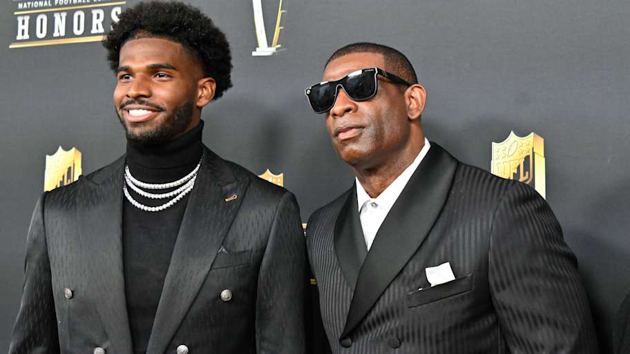 Deion Sanders shares defiant post in pink suit beside iced-out son Shedeur
