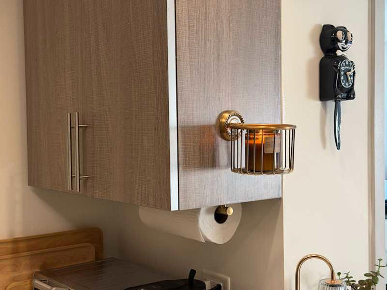 I put a toilet paper holder on my kitchen cabinet, and it looks even ...
