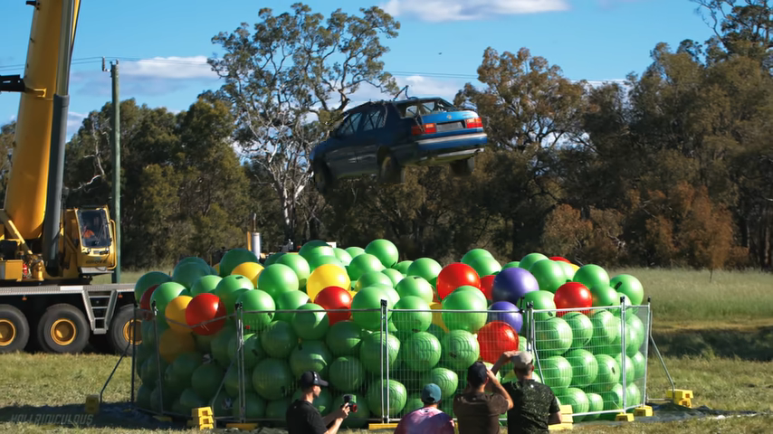 Can 1,000 exercise balls actually bounce a falling car?