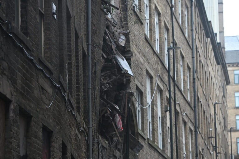 Moment abandoned building collapses – leaving piles of rubble on road