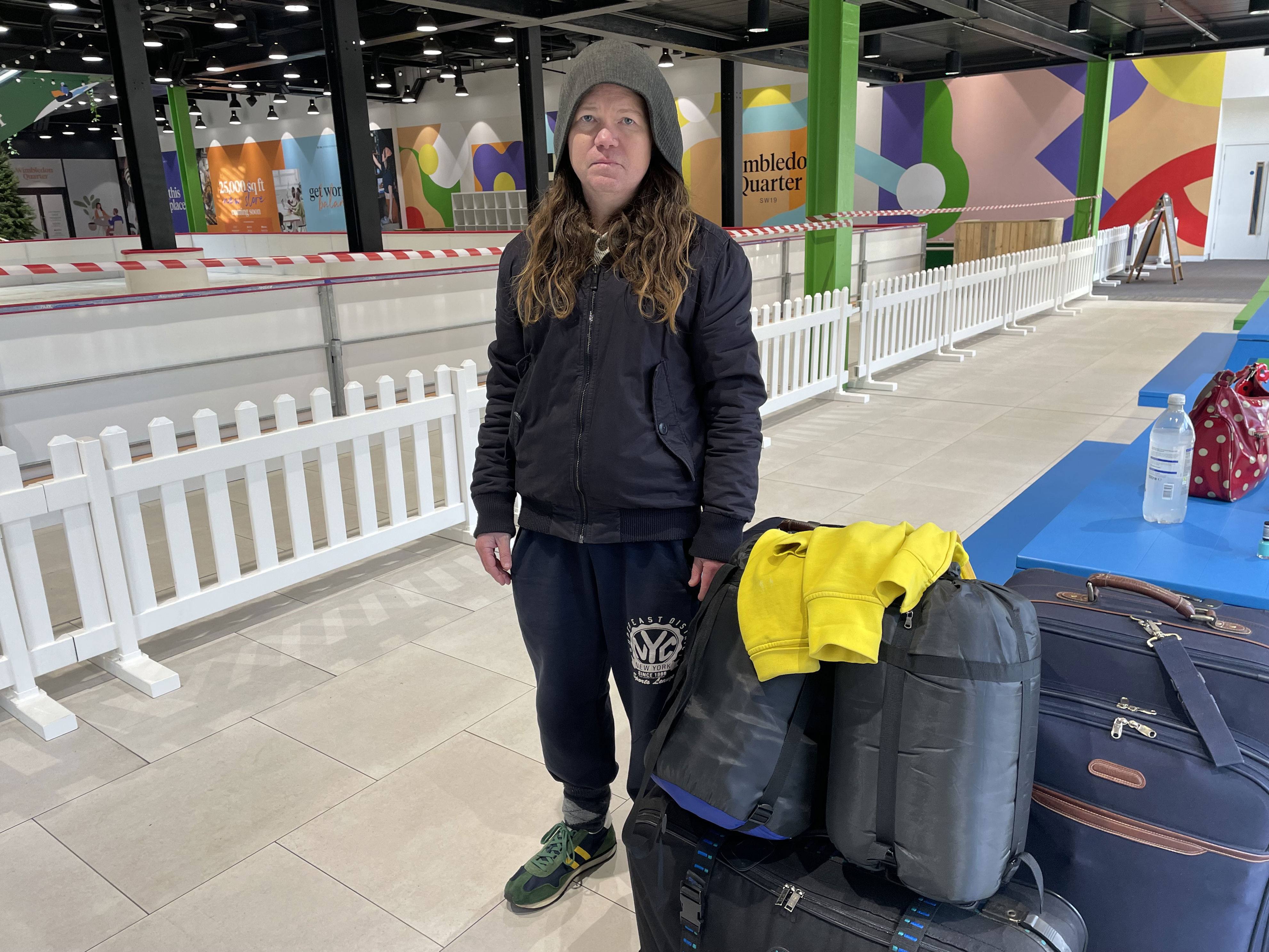 Homeless man living outside shopping mall at Xmas