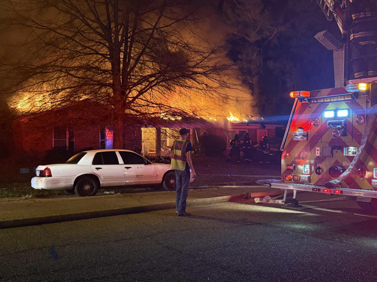 Firefighters bust door with axes to rescue man from burning home in Jackson