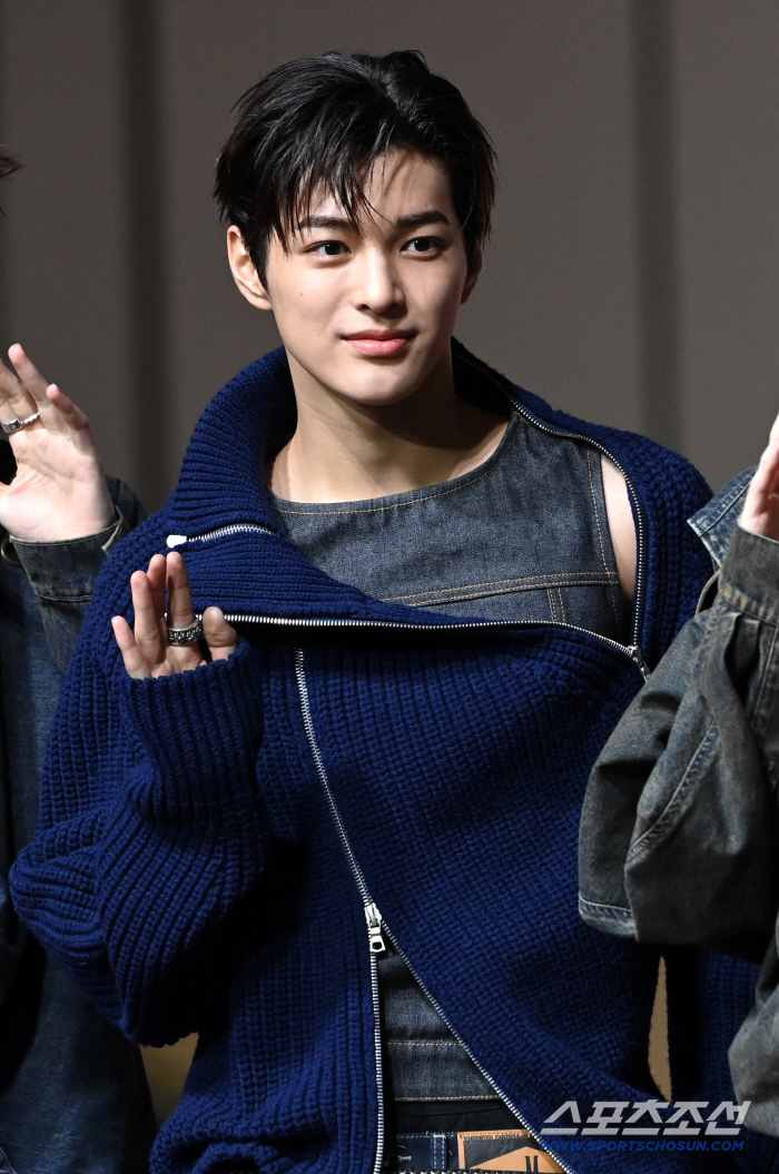 Cortis Keonho says hello with his hands showing off his beauty