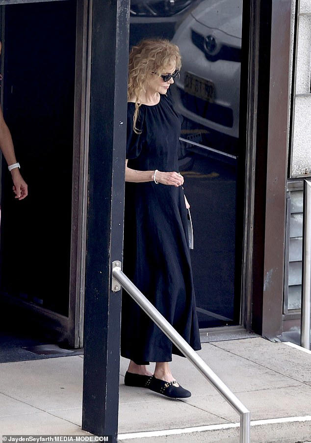 Nicole Kidman looks solemn in a modest black dress as she attends ...