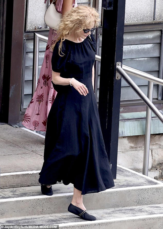 Nicole Kidman looks solemn in a modest black dress as she attends ...