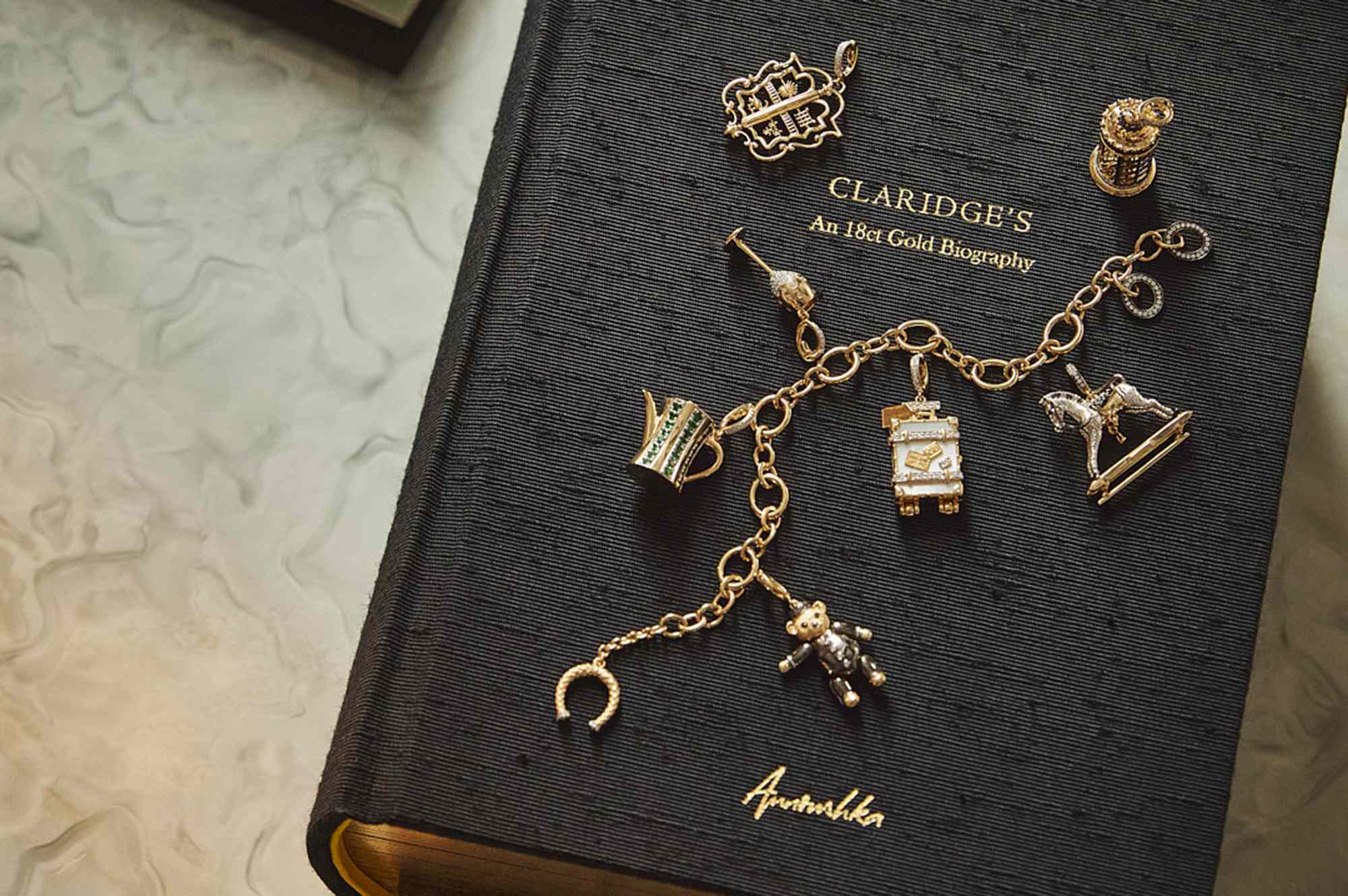 This iconic London hotel just released a stunning gold charm collection ...
