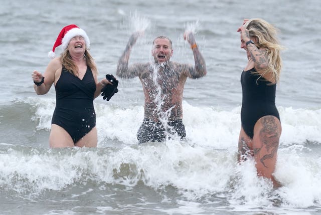 In pictures: Hardy swimmers and royal watchers brave cold Christmas Day