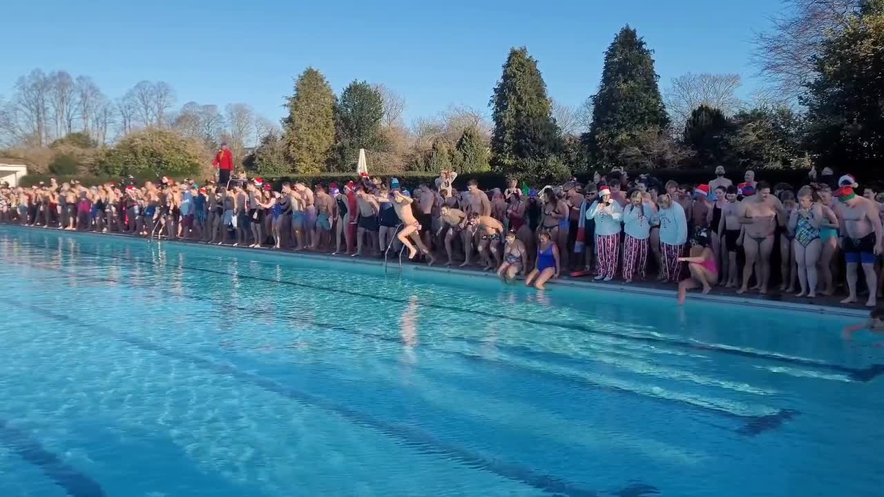 Thrillseekers leap into icy pool during Christmas Day swim in Cheltenham