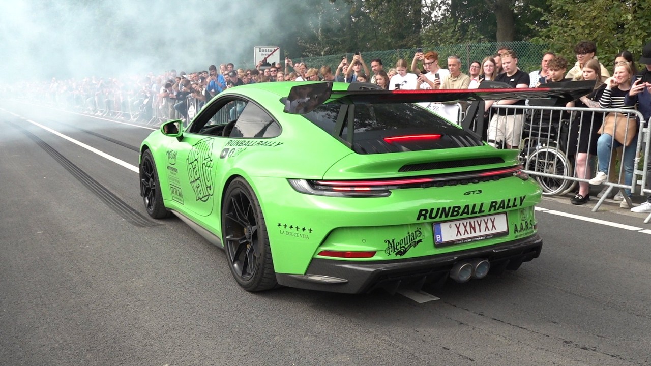 Porsche 911 GT3 accelerating in front of the crowd