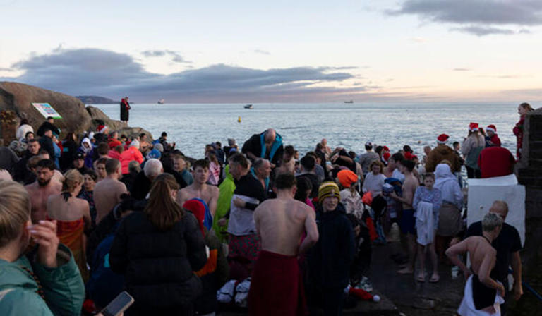 Chilly swimmers brave the icy waters for annual Christmas Day plunge