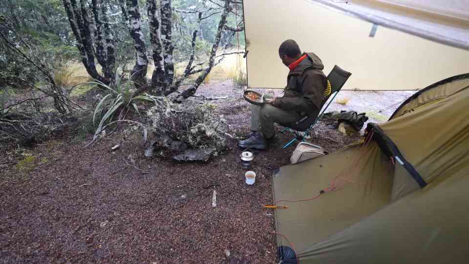 Storm's over, waffles are on: A robin joins our peaceful camp breakfast