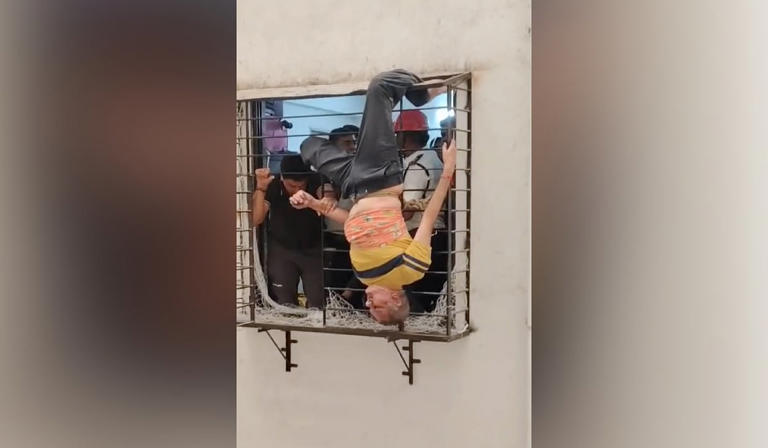Firemen save man trapped mid-air on 10th floor after fall from Surat ...