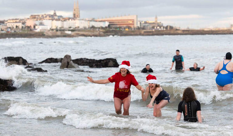 Chilly swimmers brave the icy waters for annual Christmas Day plunge