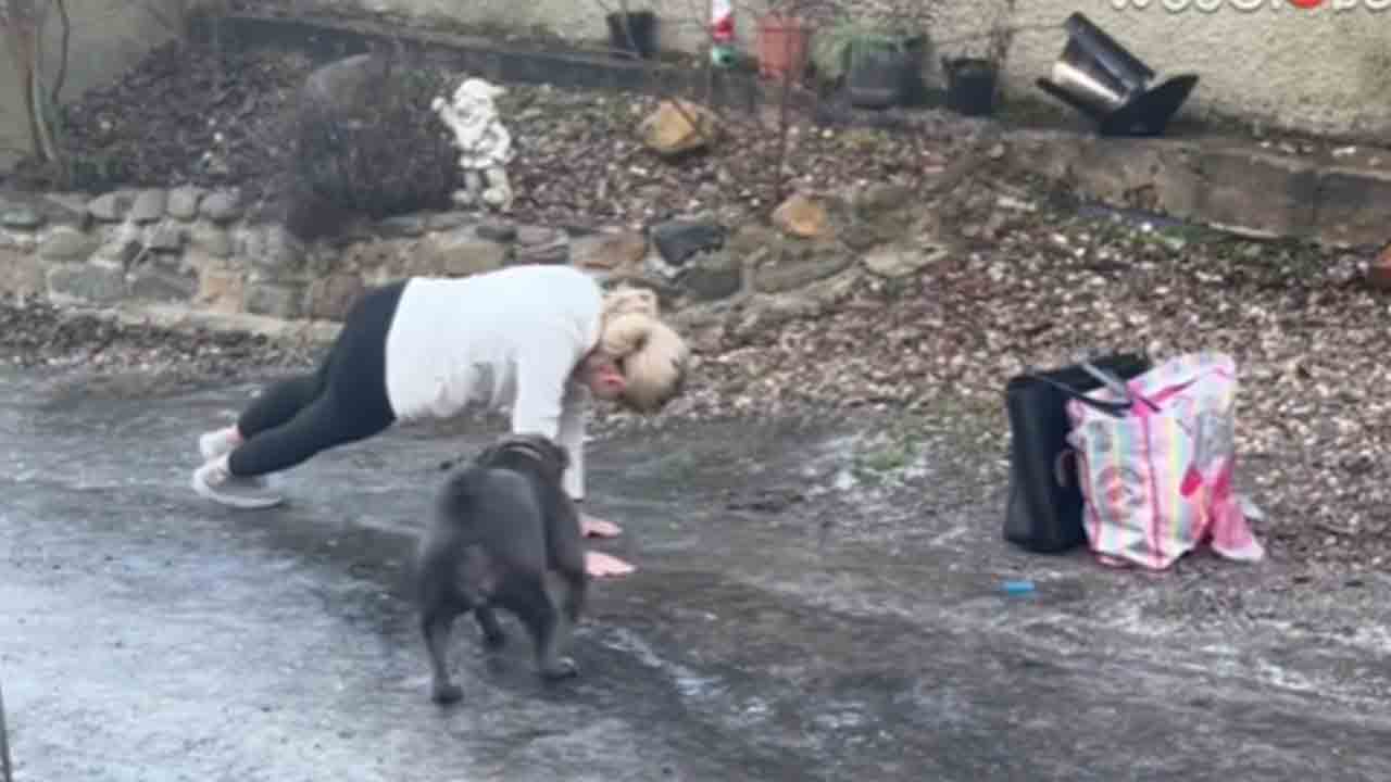 Woman uncontrollably slips in another direction due to black ice on the ...