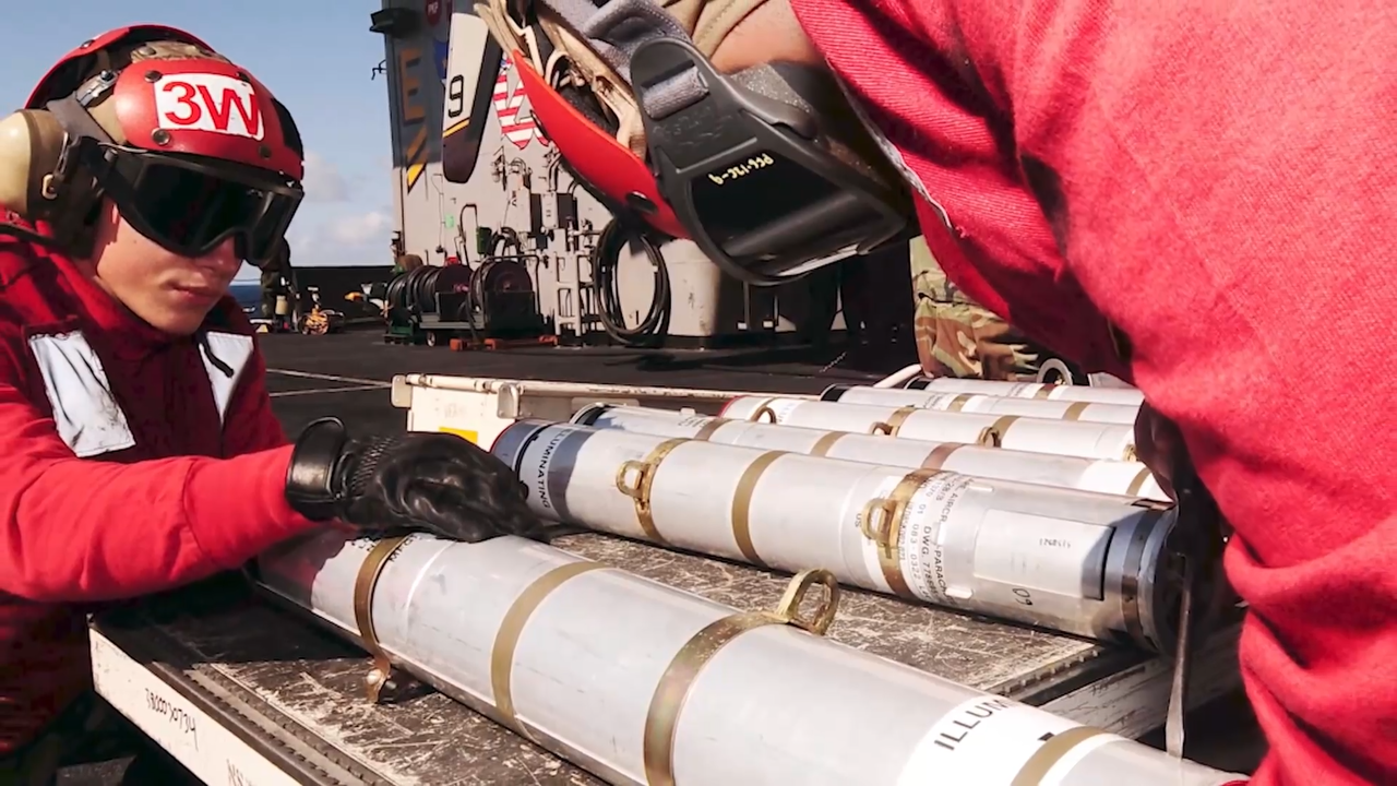 Unexploded bomb skips across carrier deck and detonates on camera