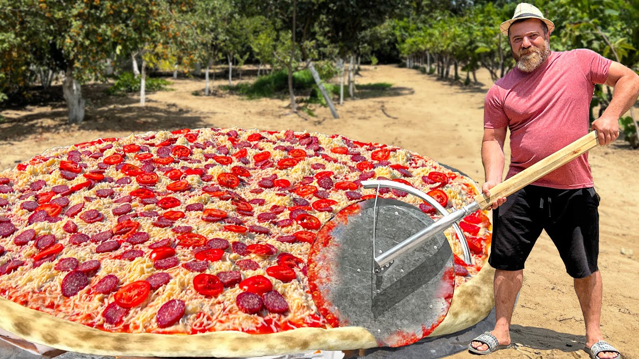 How a massive pizza is cooked directly on hot coals