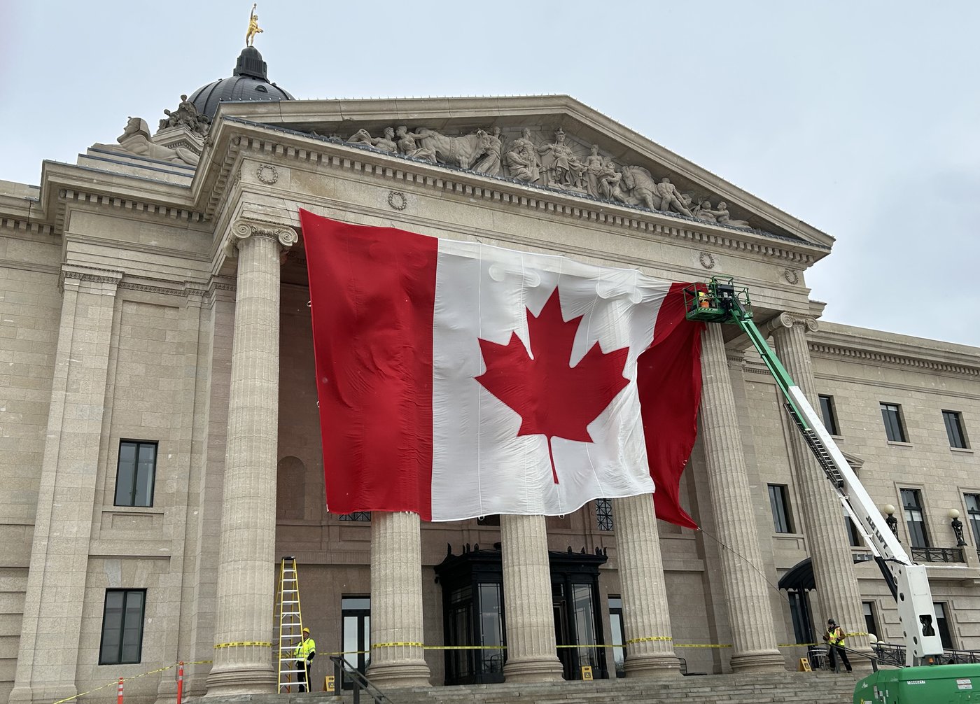 Large flag that was draped outside Manitoba's legislature is back with ...