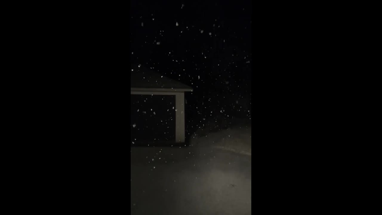 Nighttime snowfall creates snow globe effect in Boston, Massachusetts, USA