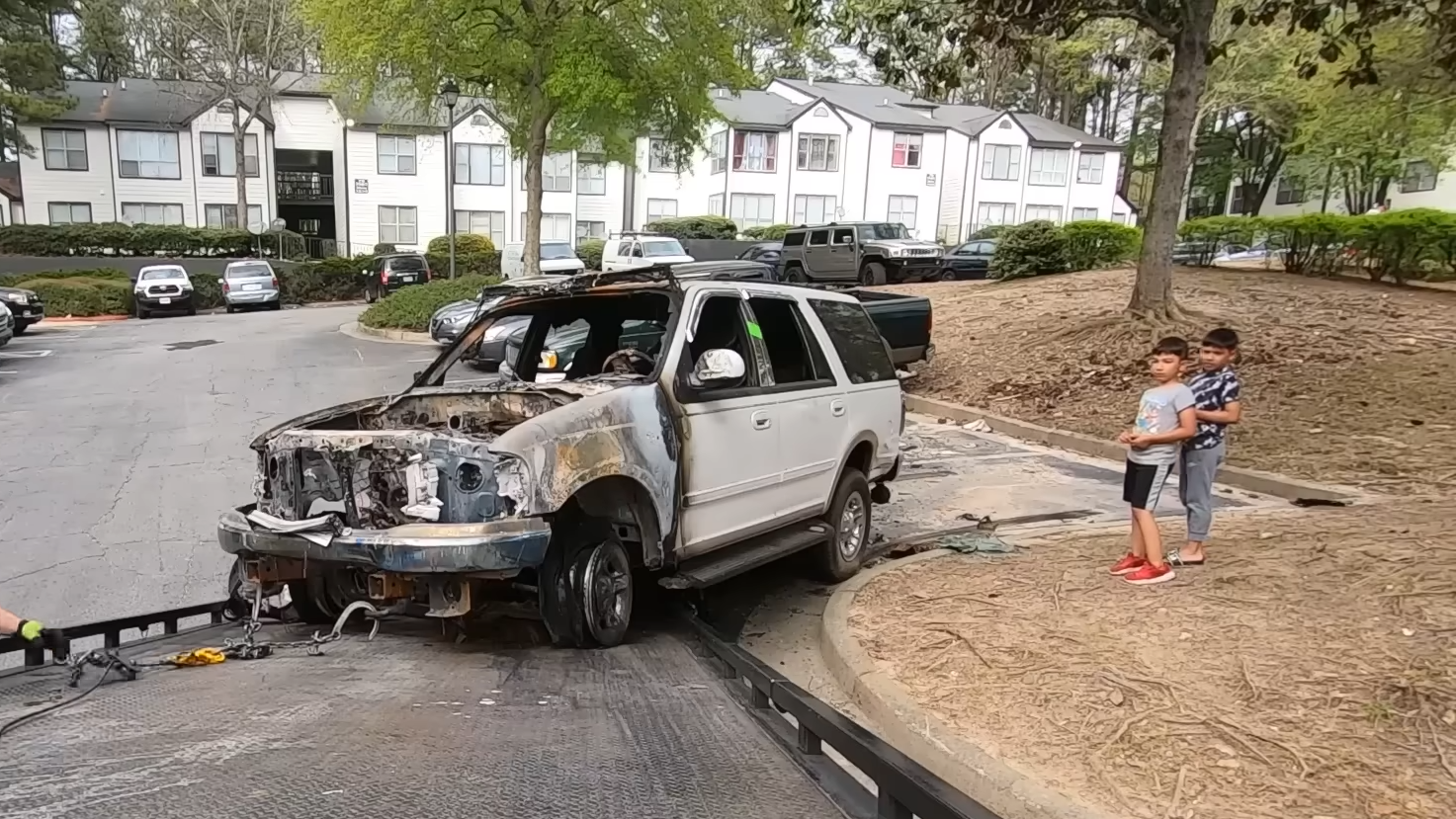 Kids say a bad guy bombed this car - tow trucker just hooks it up