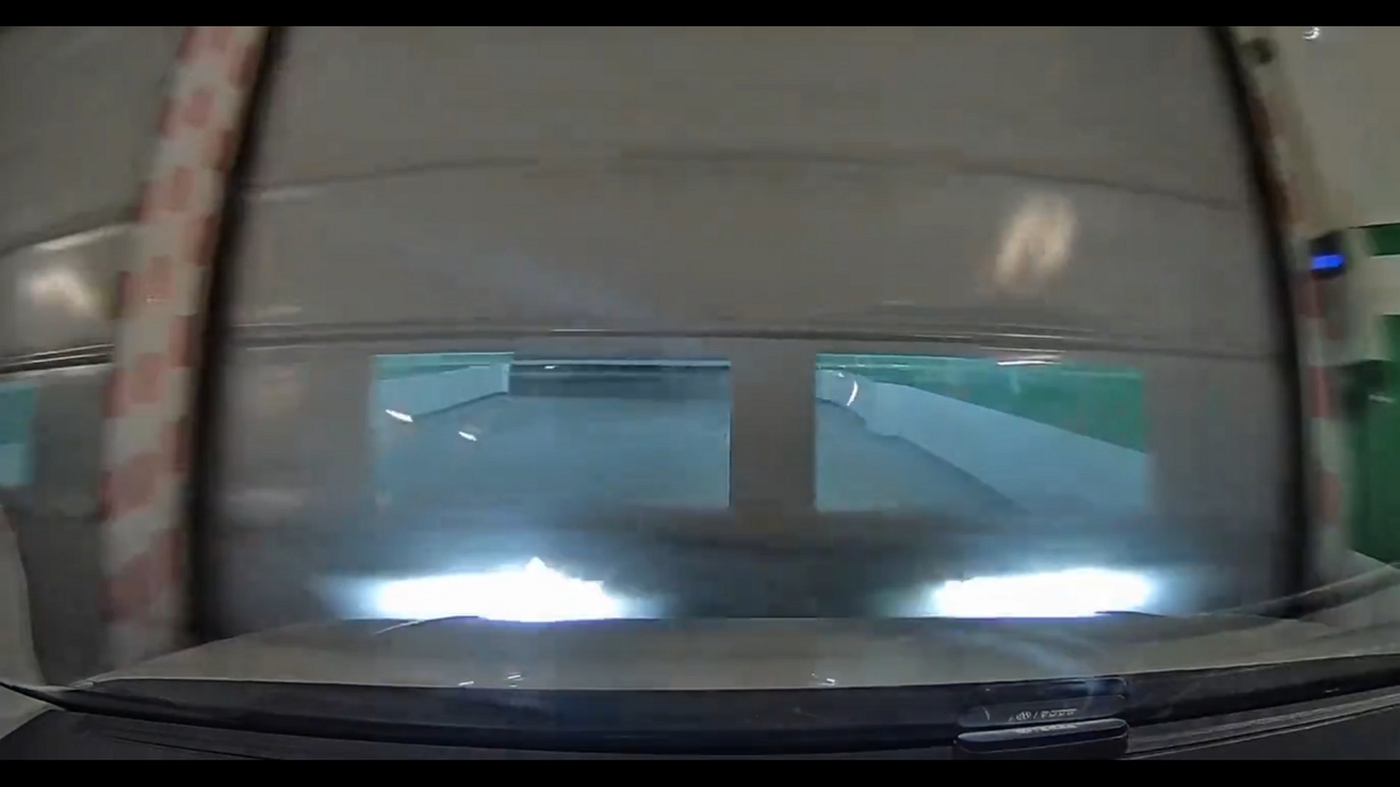 Car crashes into stuck garage door in Beijing, China