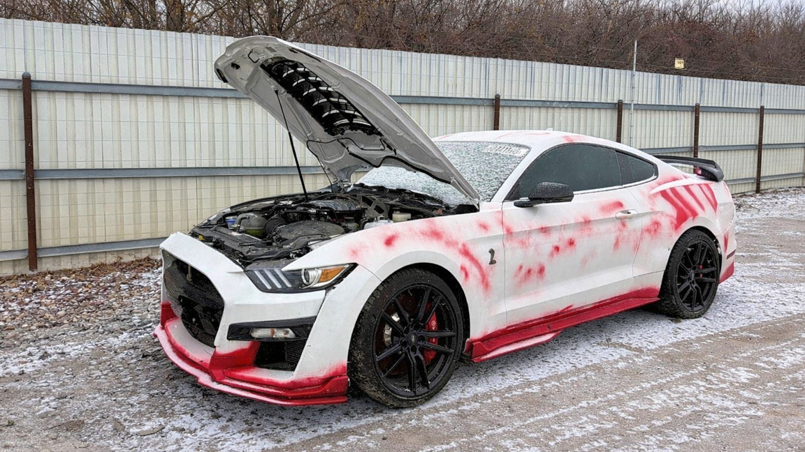 A vandalized sports car found at auction