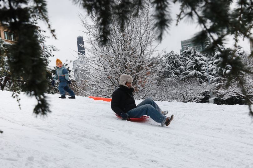 New Yorkers sled through historic snowfall after massive polar blizzard ...