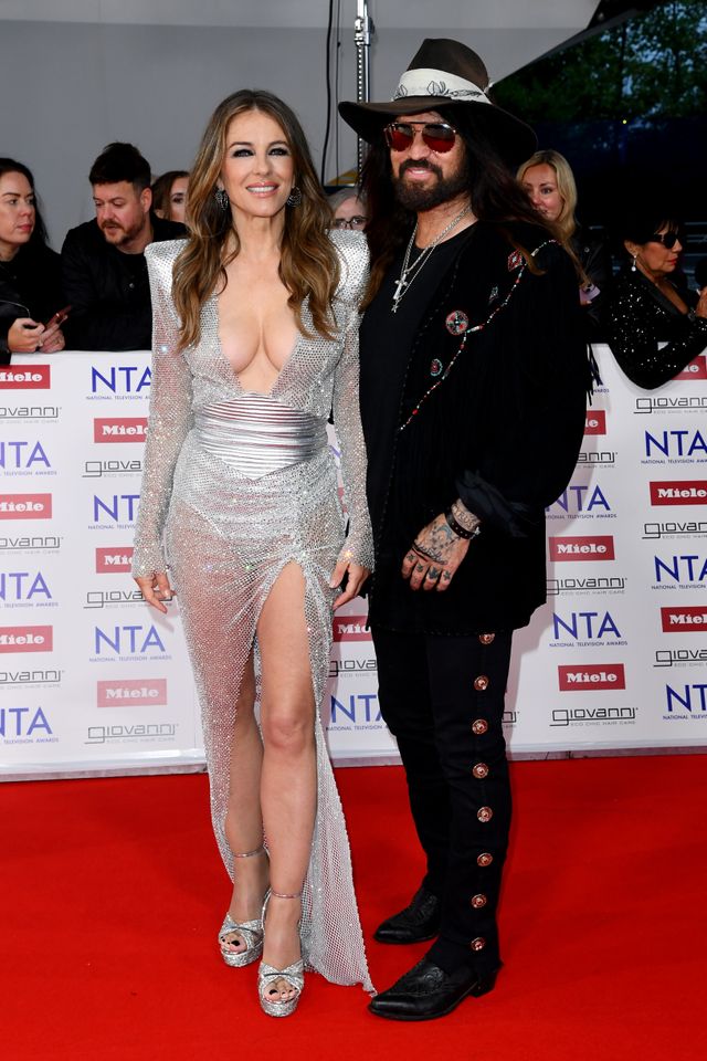 Elizabeth Hurley and Billy Ray Cyrus match in festive looks for PDA ...