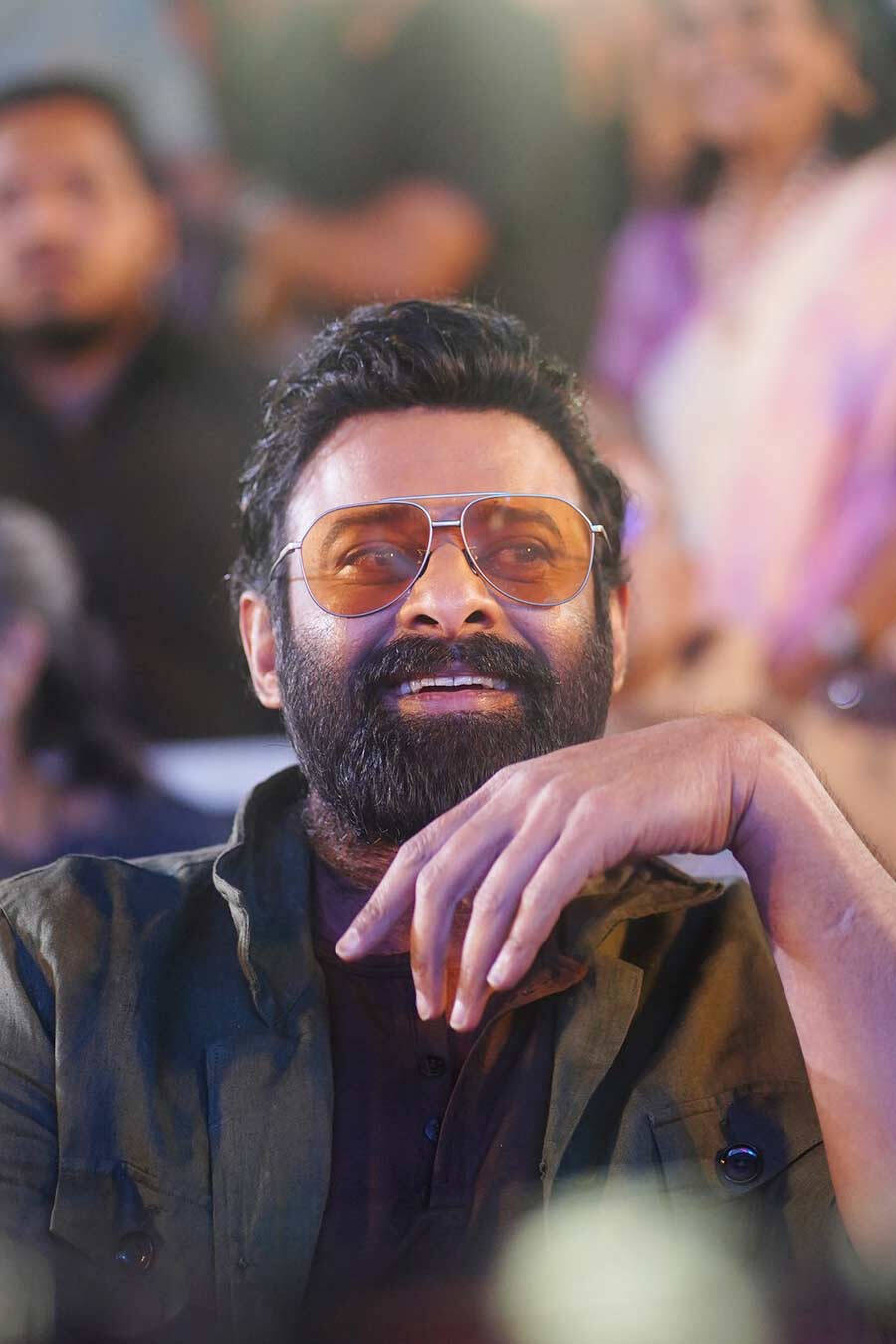 Pics: Prabhas flaunts a man bun at the Raja Saab pre-release event