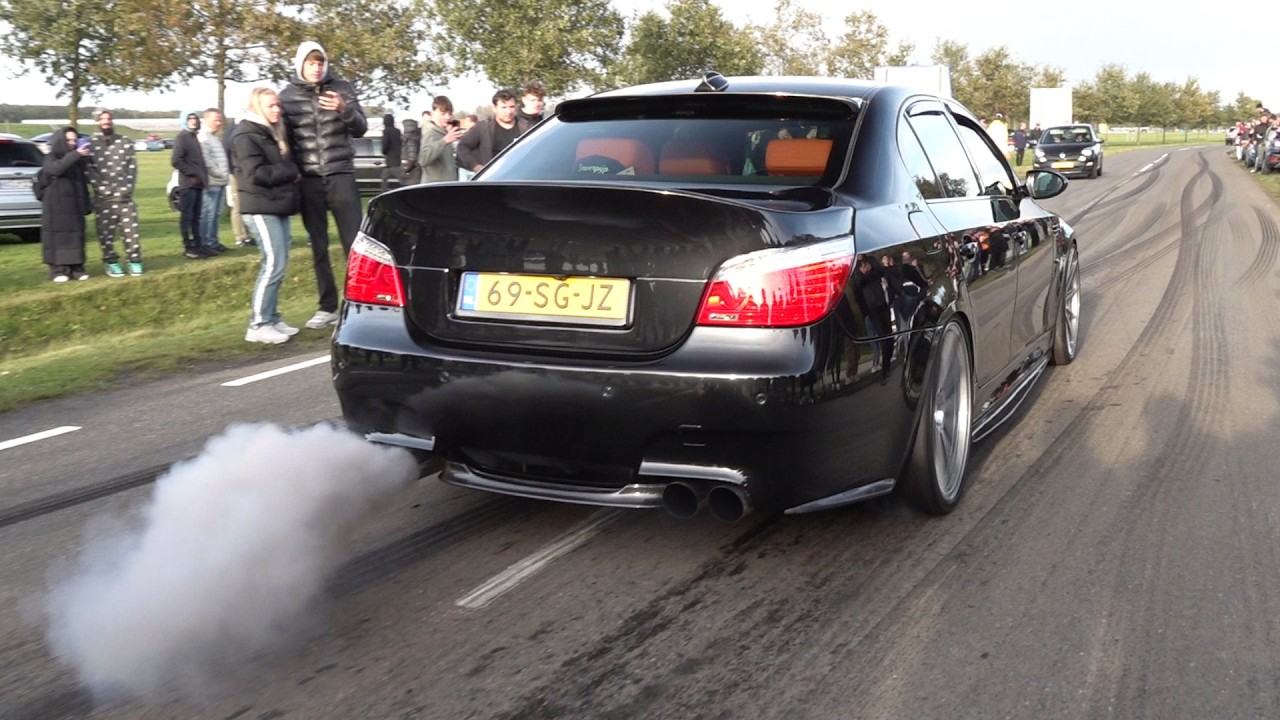BMW sedan beginning its run on a closed road with spectators