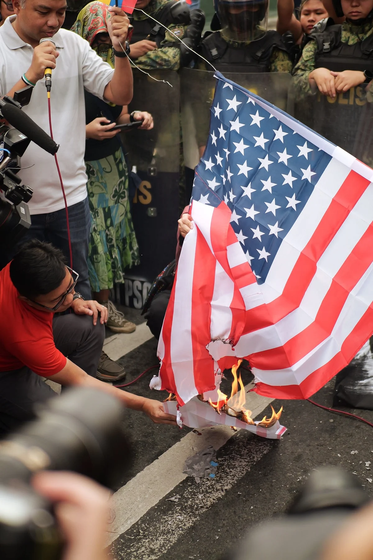 Over 200 Filipinos burn US flags, condemn capture of Venezuelan ...