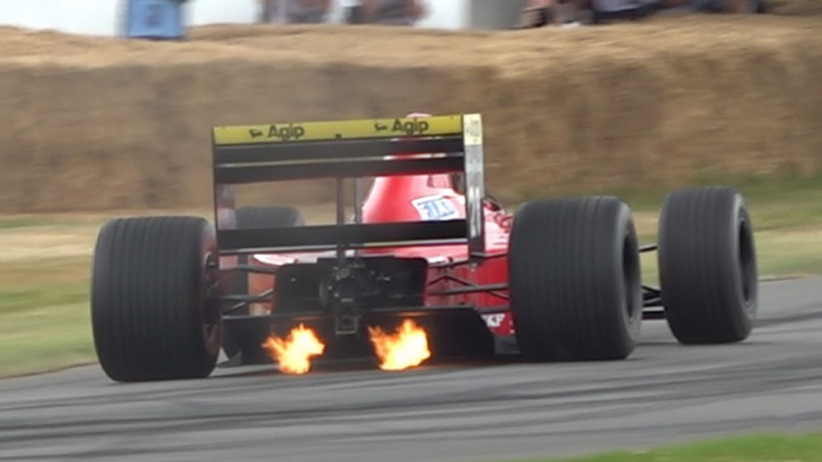 Ferrari Formula 1 car accelerates with flames on track