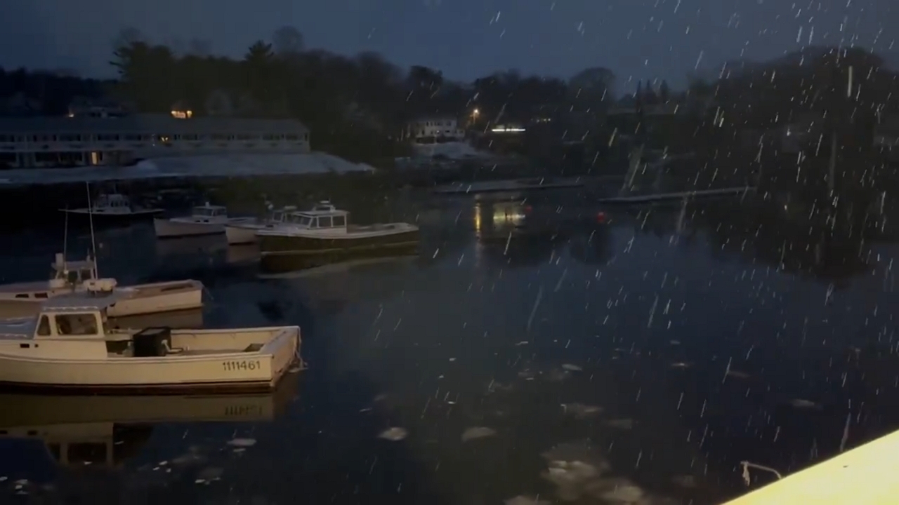 Gentle snowfall blankets Ogunquit Harbor at dusk, Maine, USA