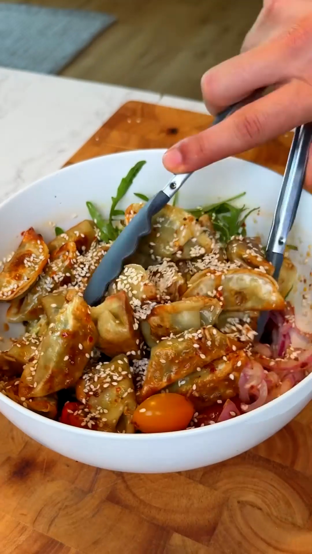 Mixing crisp veggies with hot dumplings