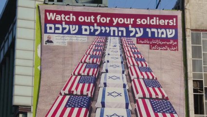 Banner showing US and Israel coffins lining ground displayed in Iran ...