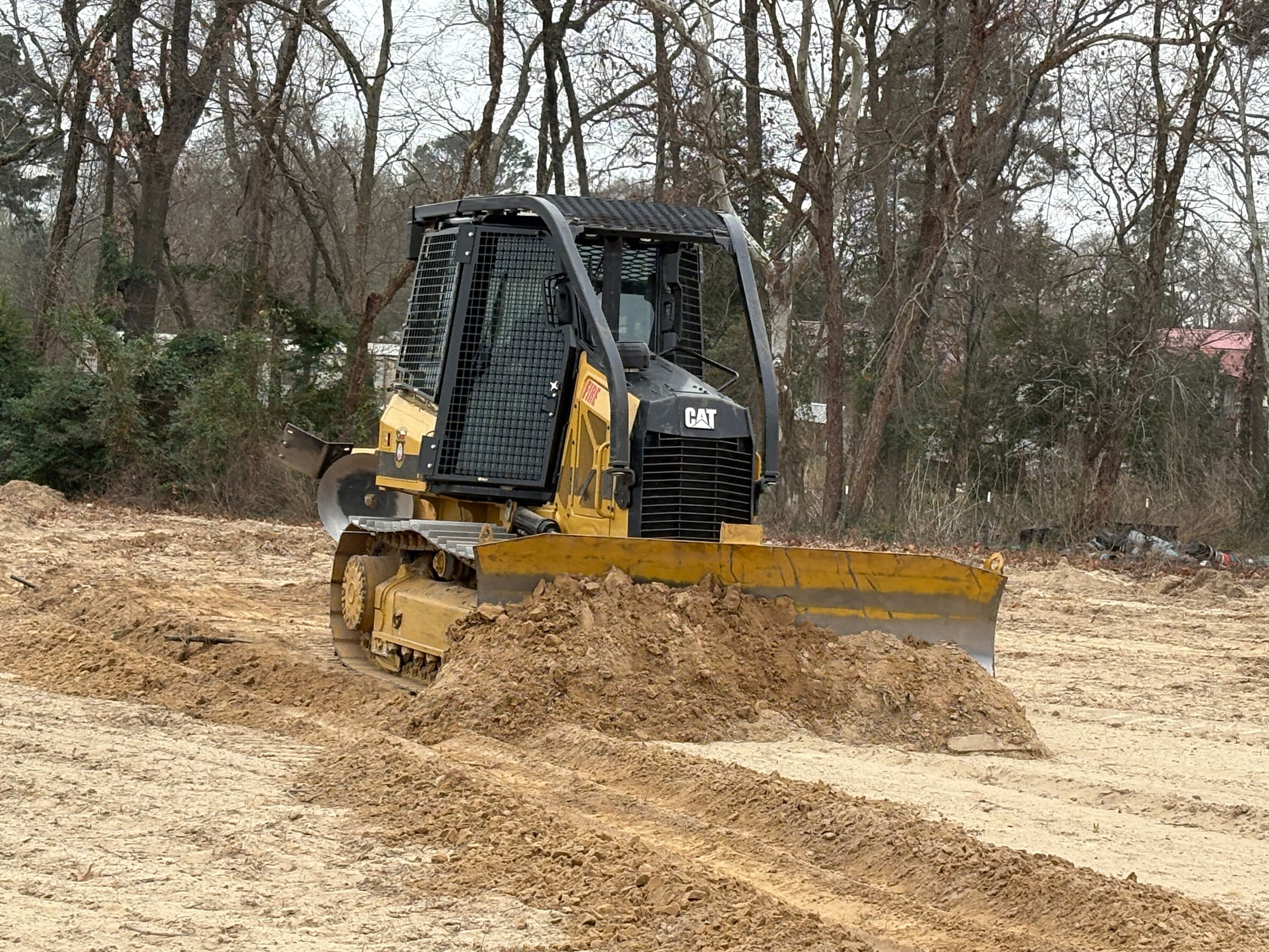 Smith County firefighters use dozers to combat grass fires