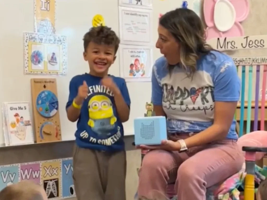 Teacher plays a mystery reader audio message then one little boy lights up